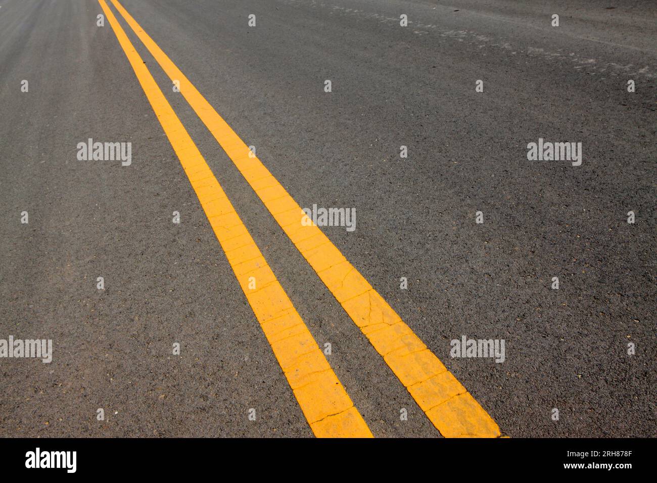 yellow double solid line on the road Stock Photo - Alamy