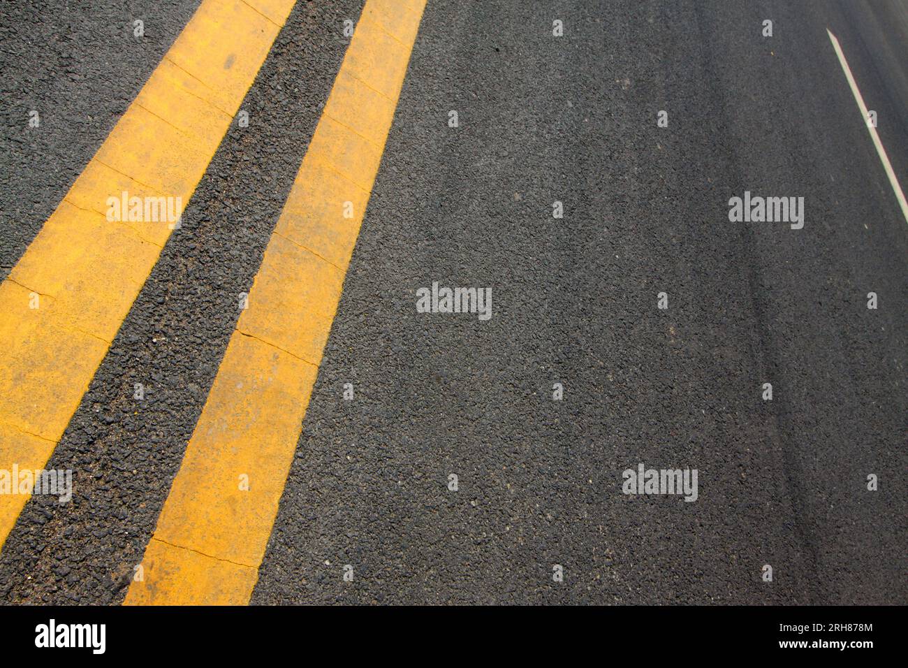 yellow double solid line on the road Stock Photo - Alamy