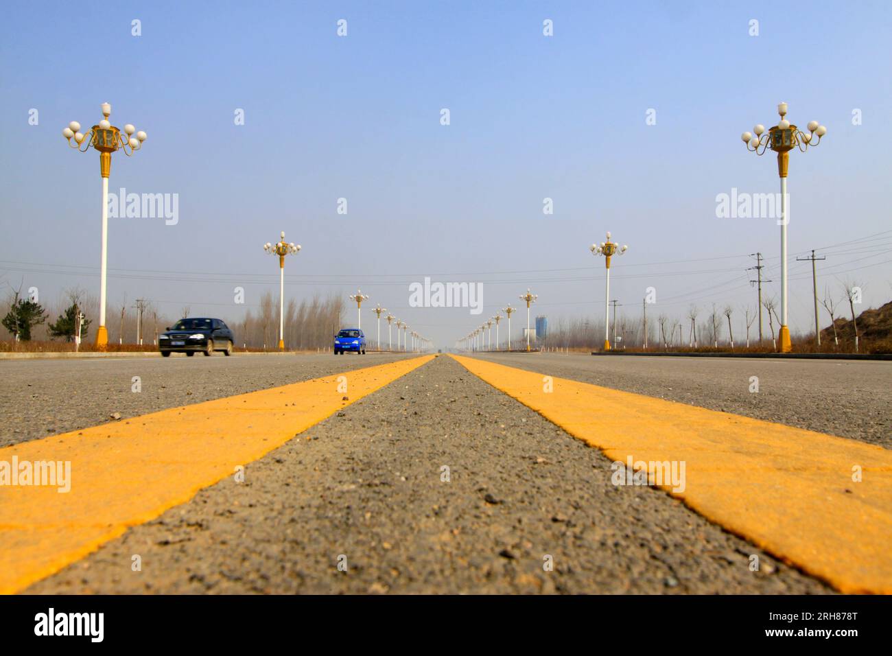 yellow double solid line on the road Stock Photo - Alamy