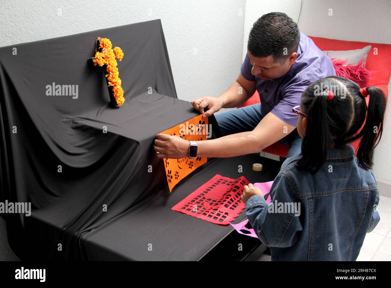 Mexican dad and daughter put the altar and offering of the Day of the ...