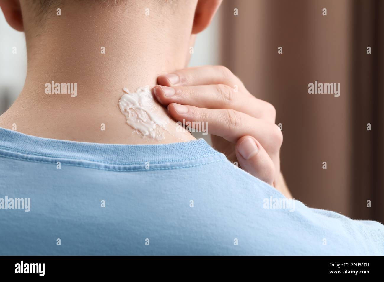 Man applying ointment onto his neck indoors, closeup Stock Photo - Alamy