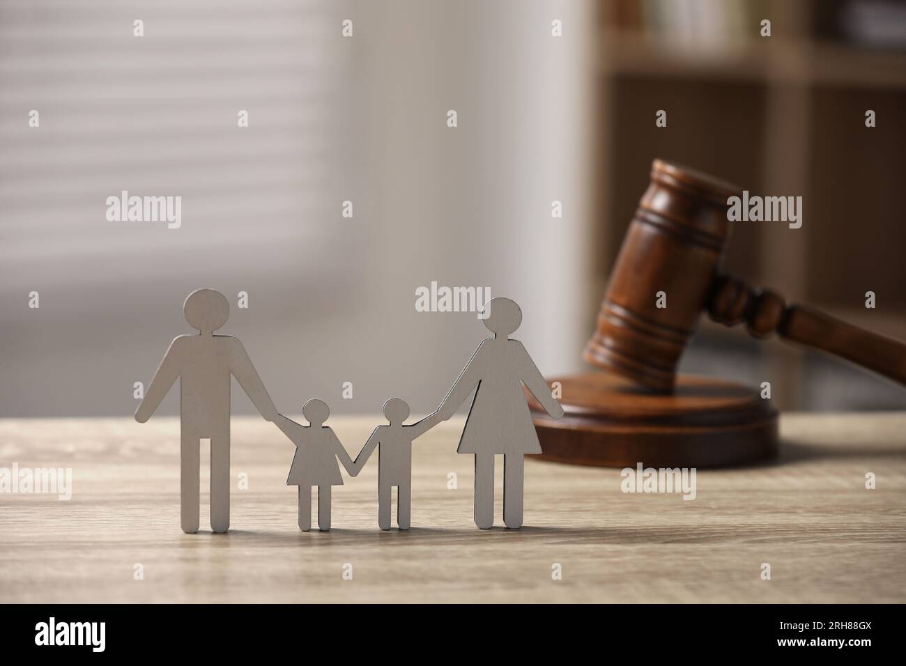 Family law. Figure of parents with children and gavel on wooden table ...