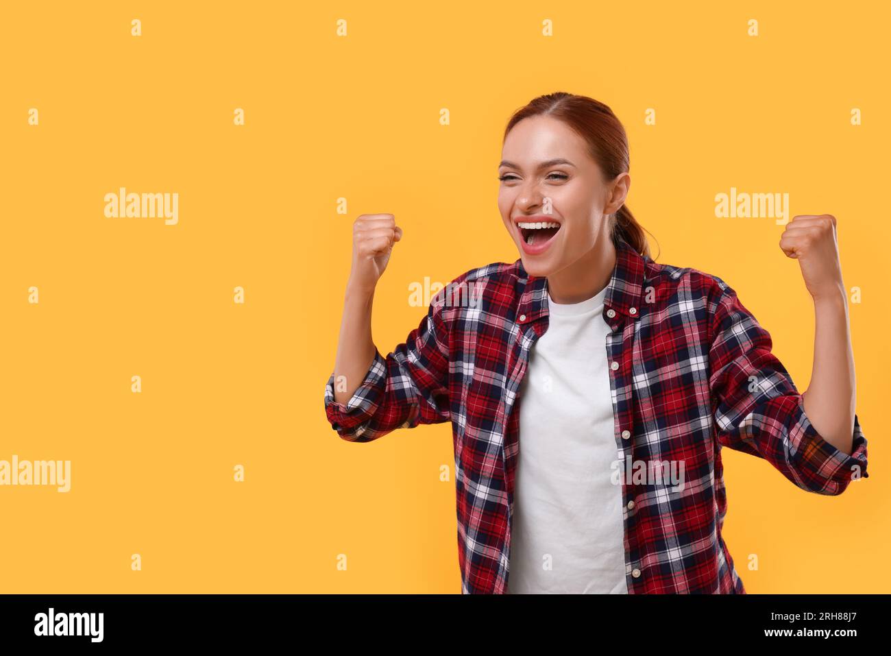 Happy fan celebrating on yellow background, space for text Stock Photo ...
