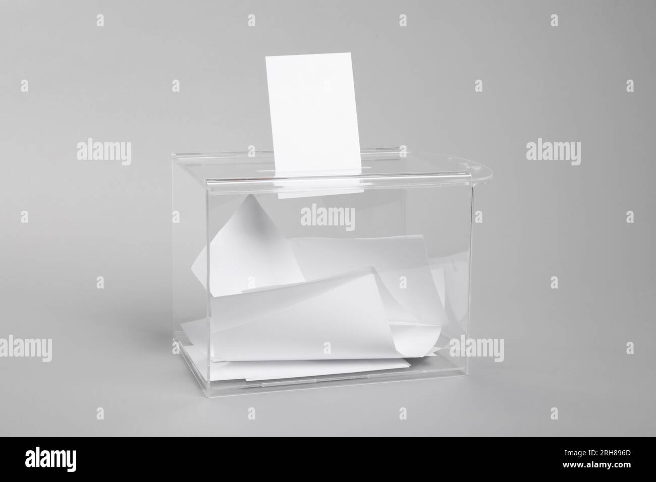 Ballot box with votes on light grey background. Election time Stock ...