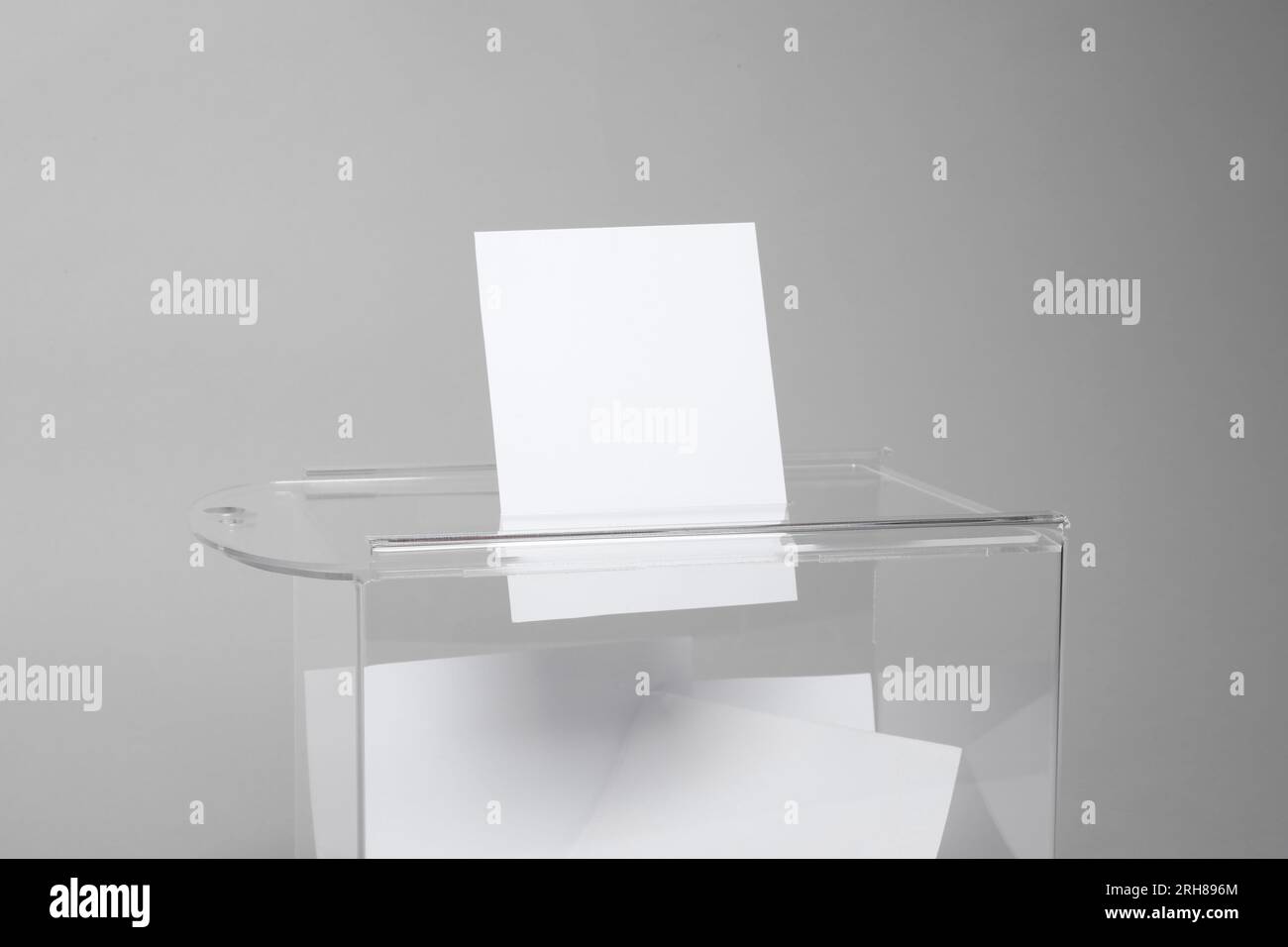 Ballot box with votes on light grey background. Election time Stock ...