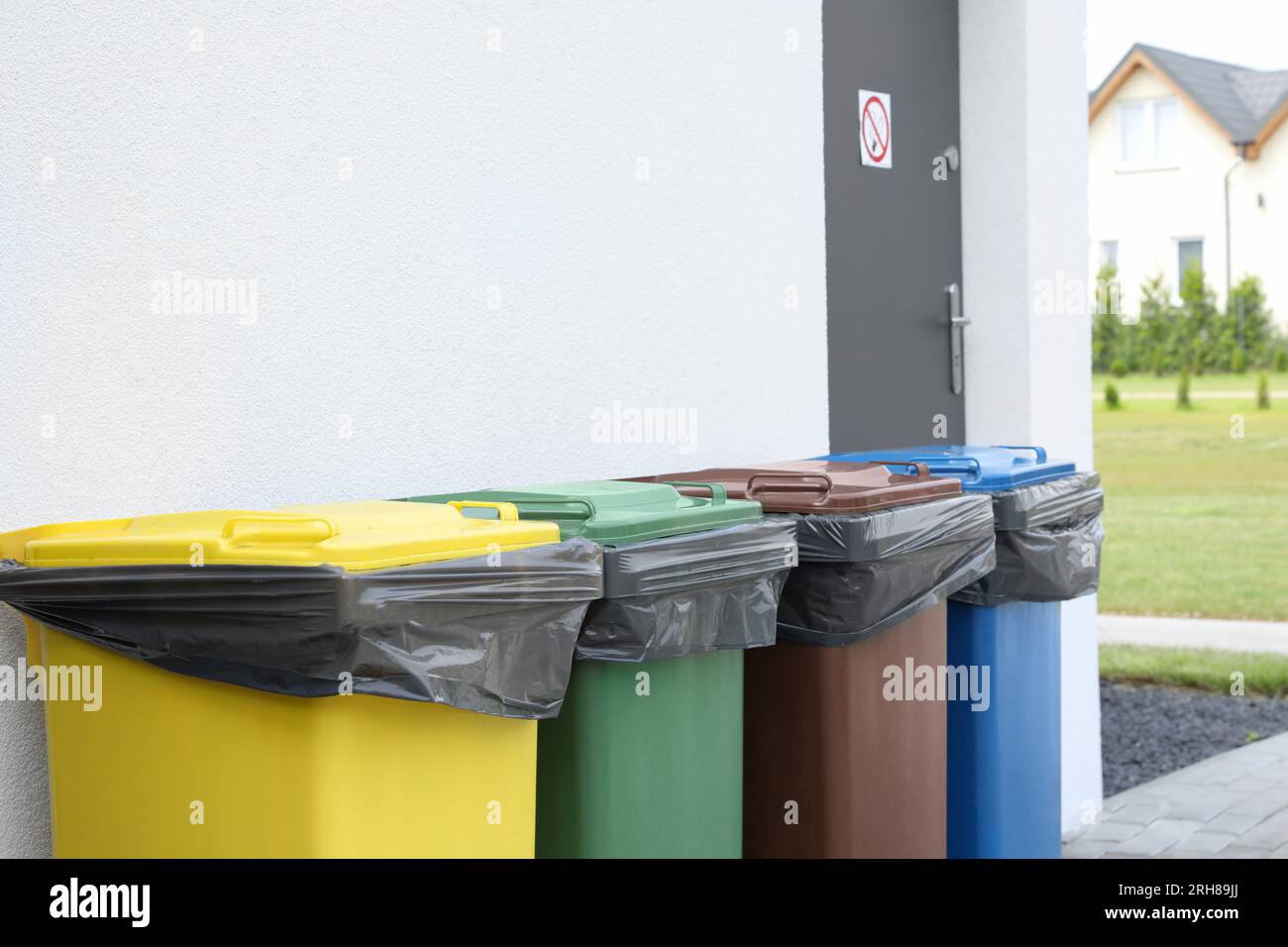 Recycling bins for different garbage outdoors. Waste sorting Stock ...
