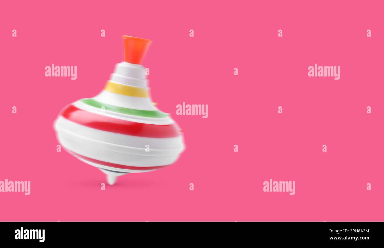 One spinning top in motion on pink background, banner design with space ...