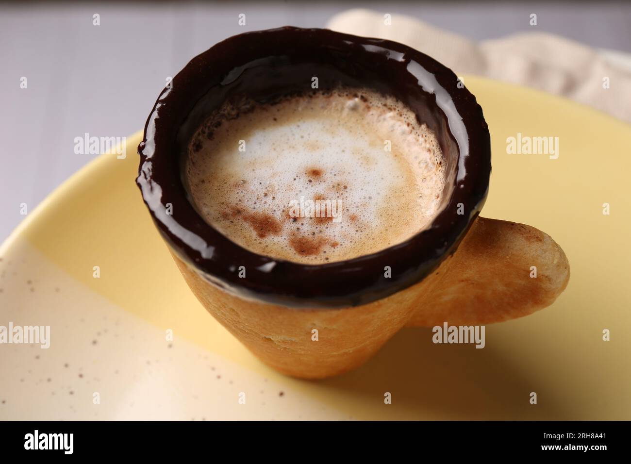 Delicious edible biscuit cup with coffee on plate, closeup Stock Photo ...