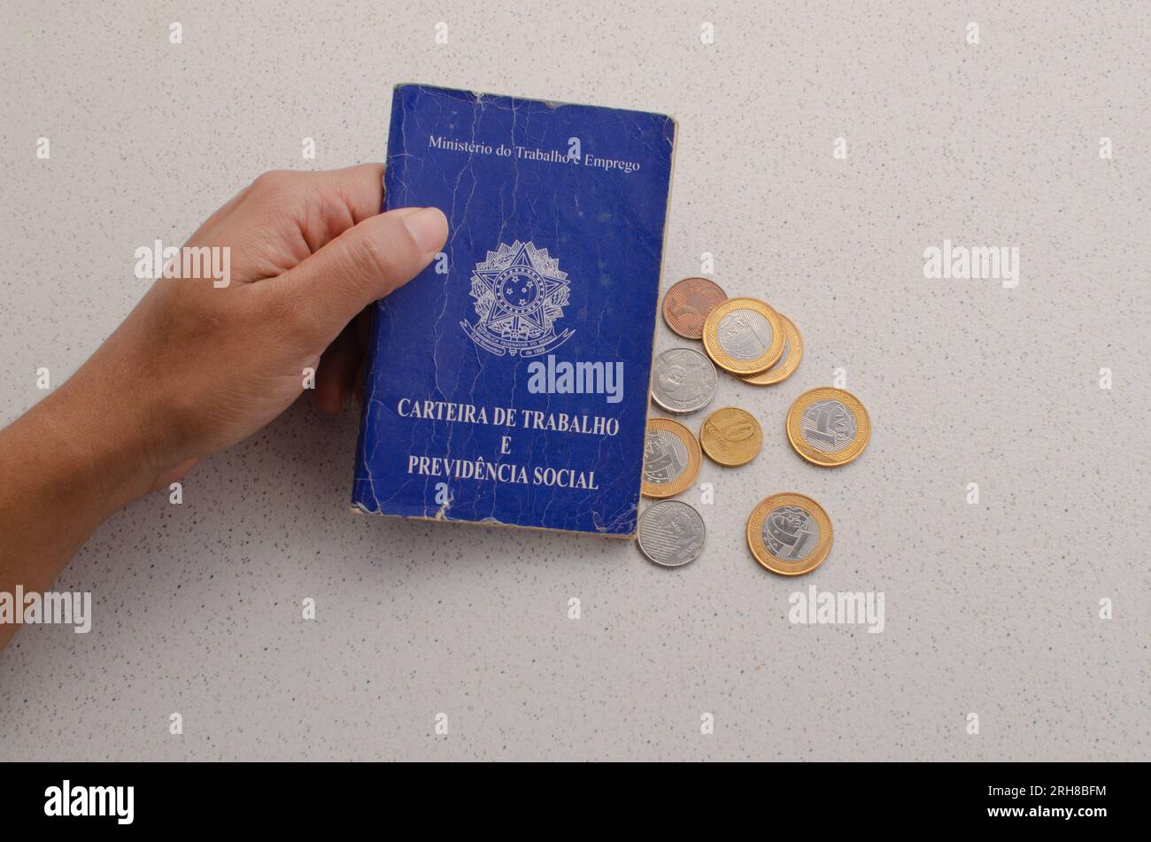 Brazilian work card displayed with money from Brazil, representing the ...