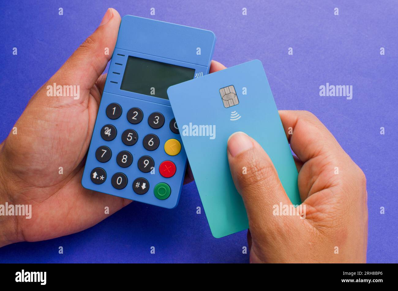 Hands holding a portable contactless payment device, An ultra-light and ...