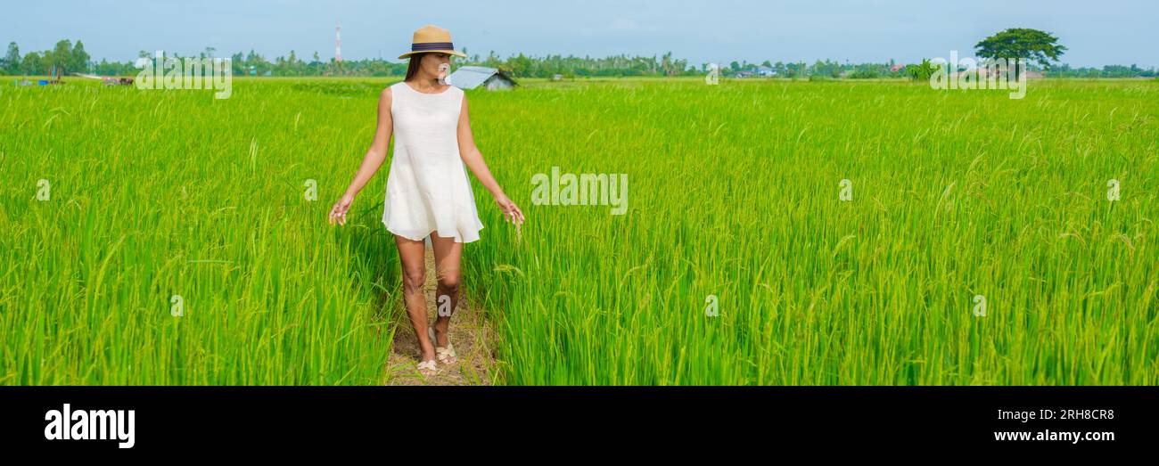 a couple of men and women on vacation in Thailand walking on a curved ...