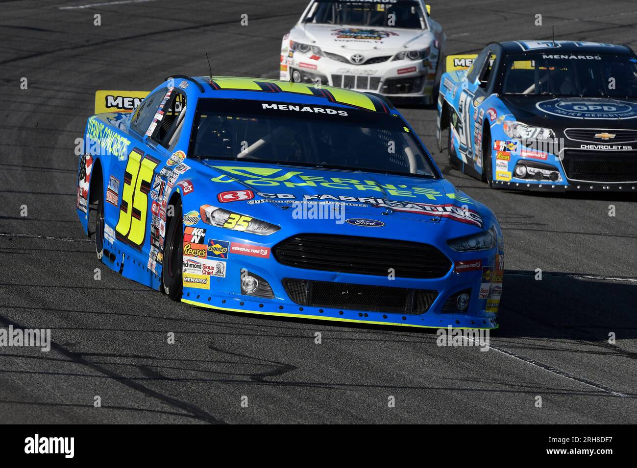 INDIANAPOLIS, IN - AUGUST 11: Greg Van Alst (35) Ford Fusion passes Rita Goulet (31) Tim Goulet ...