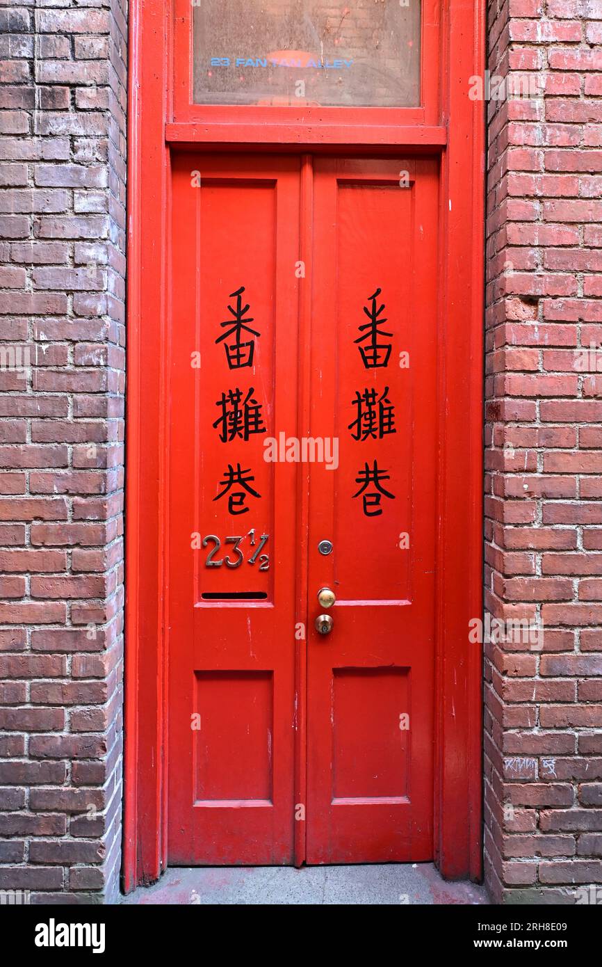Victoria, British Columbia - August 2, 2023 - Bright red door with painted black Chinese ...