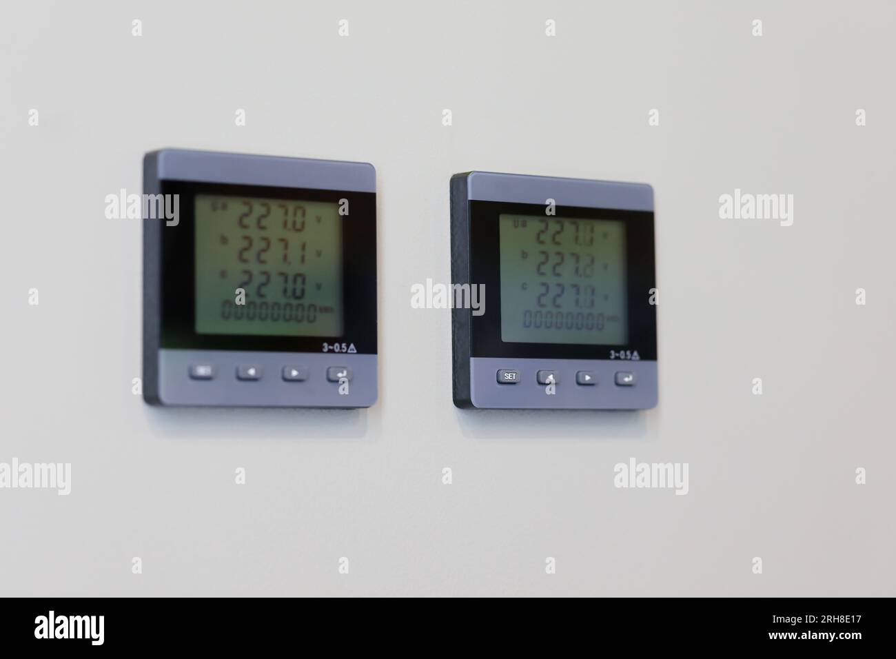 LCD digital AC voltmeters on a control panel. Selective focus Stock ...