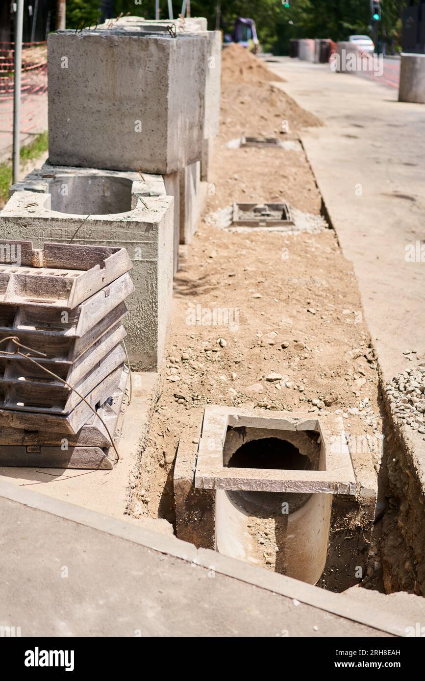 Laying concrete manholes and drain pipes for stormwater system ...