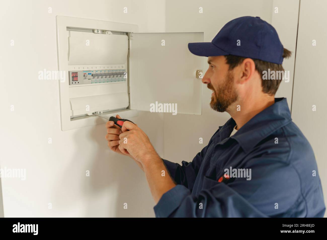 Professional male electrician inspect and repairing electrical systems ...