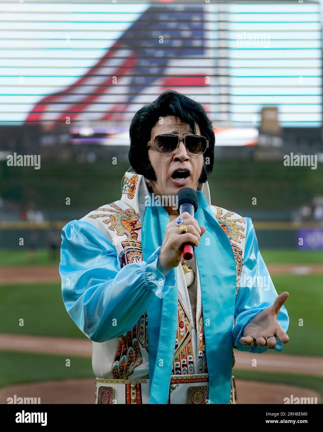 Elvis impersonator Doug Church sings the national anthem before a ...