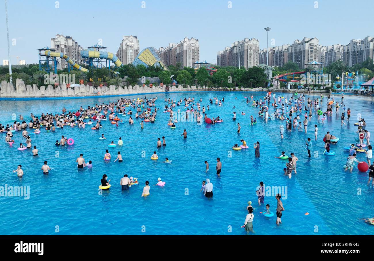Aerial photo shows people playing at a water park to escape the heat in ...