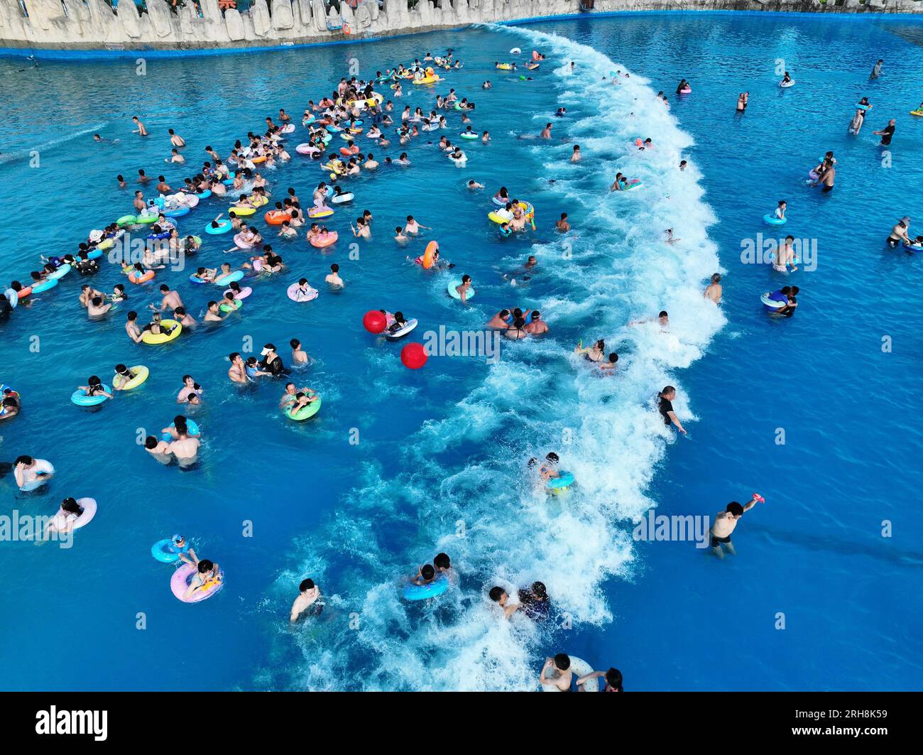 Aerial photo shows people playing at a water park to escape the heat in ...