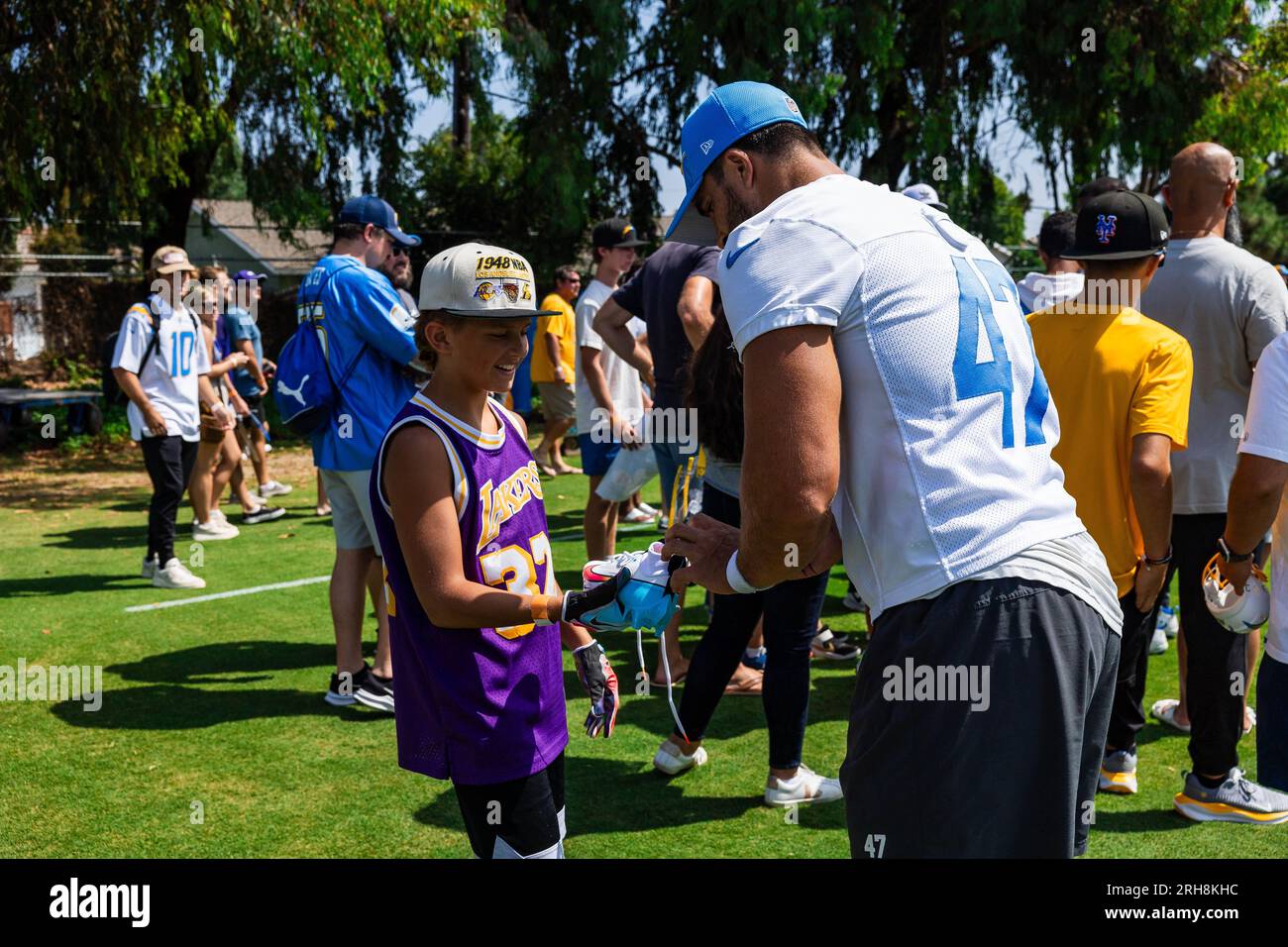 Los Angeles Chargers long snapper Josh Harris (47) give autographs to ...