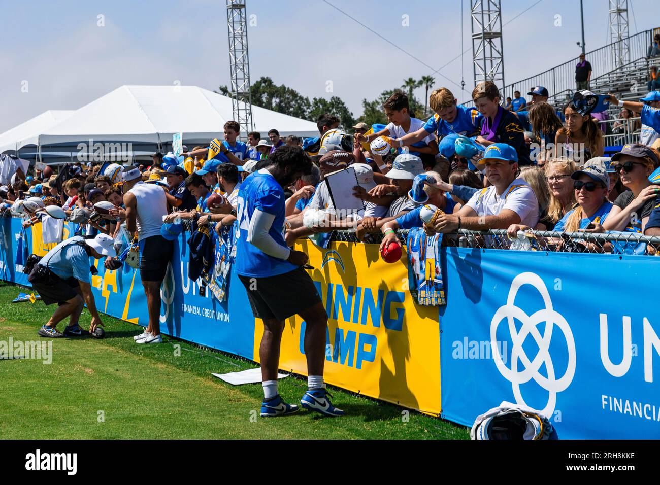 Los Angeles Chargers line backer Chris Rumph II (94) give autographs to ...