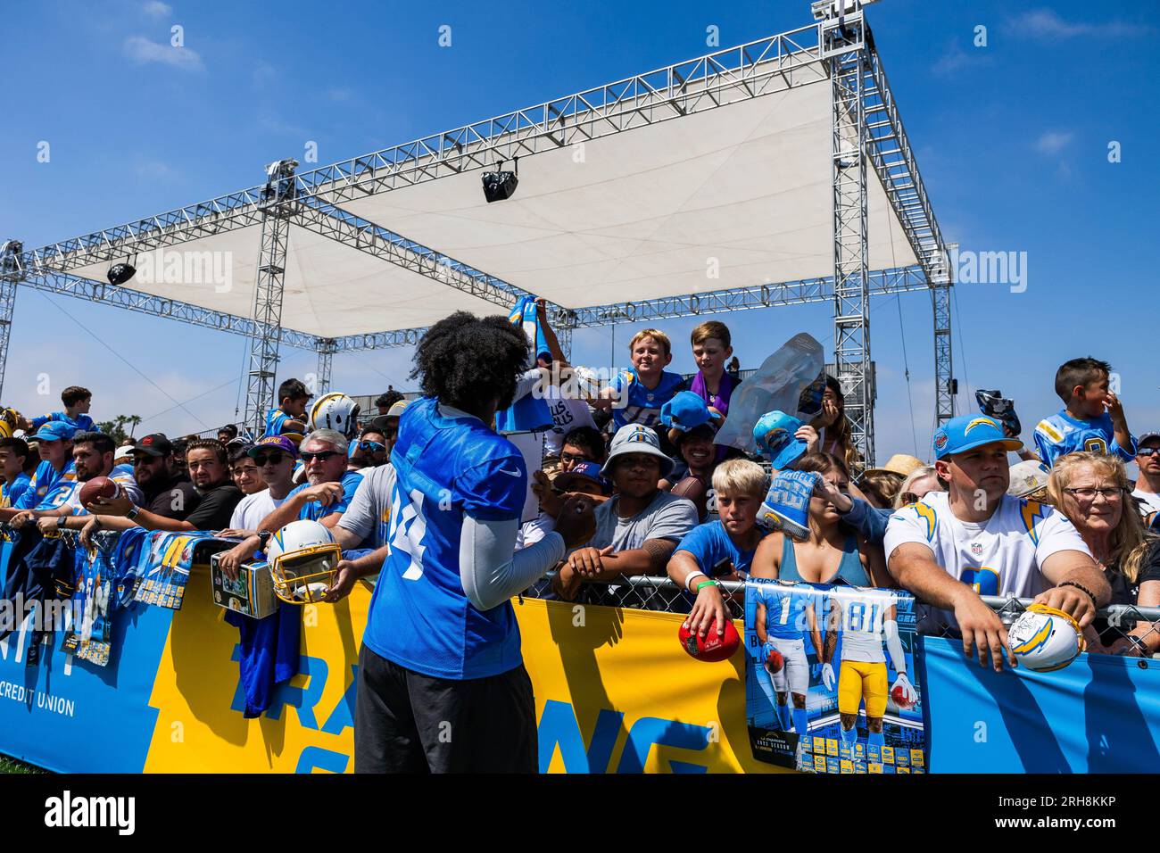 Los Angeles Chargers line backer Chris Rumph II (94) give autographs to ...