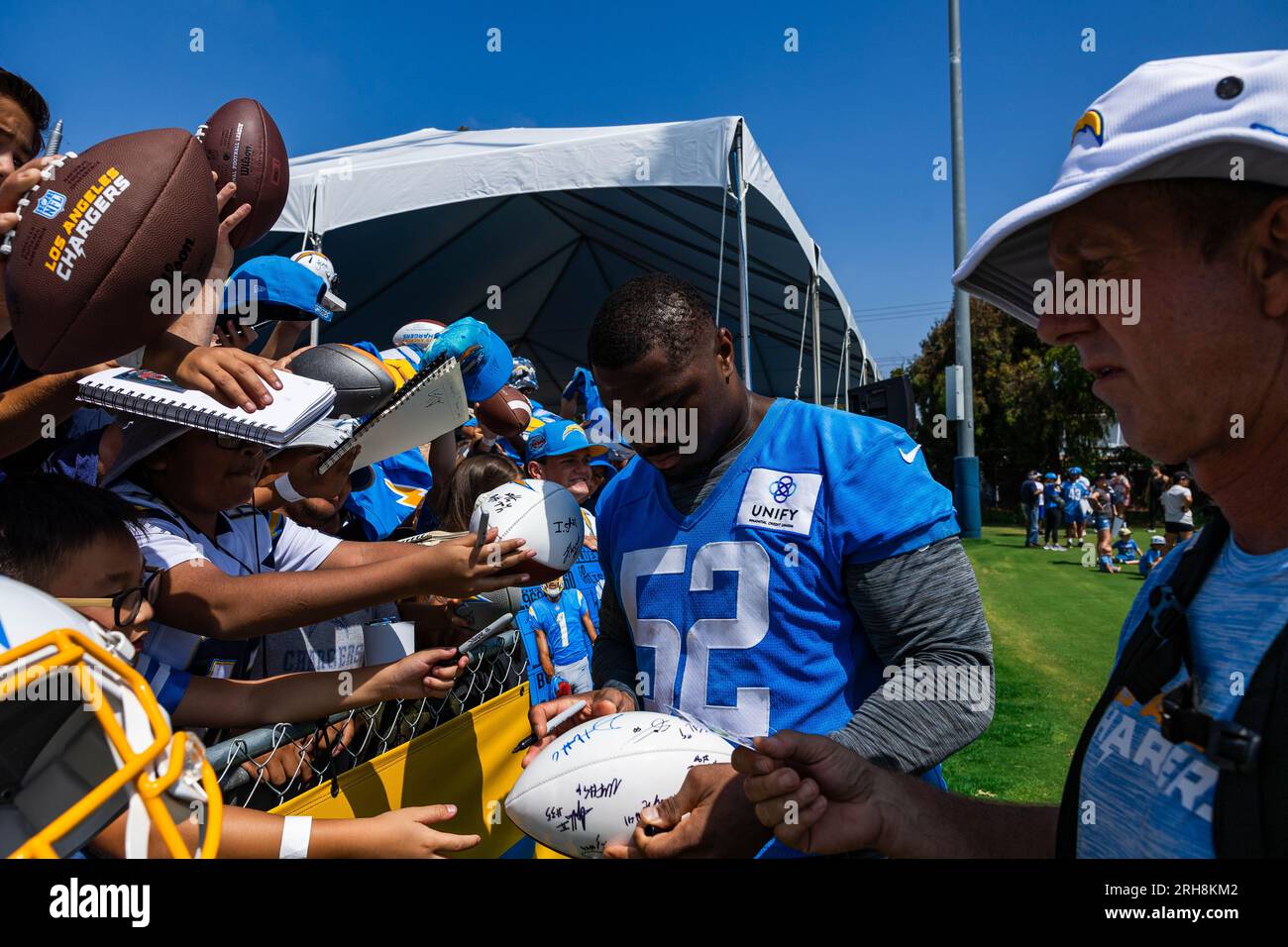 Los Angeles Chargers line backer Khalil Mack (52) give autographs to ...