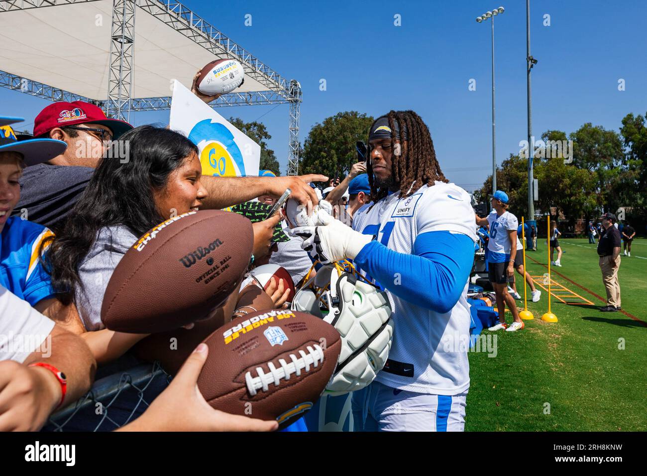 Los Angeles Chargers center Johari Branch (61) give autographs to fans ...
