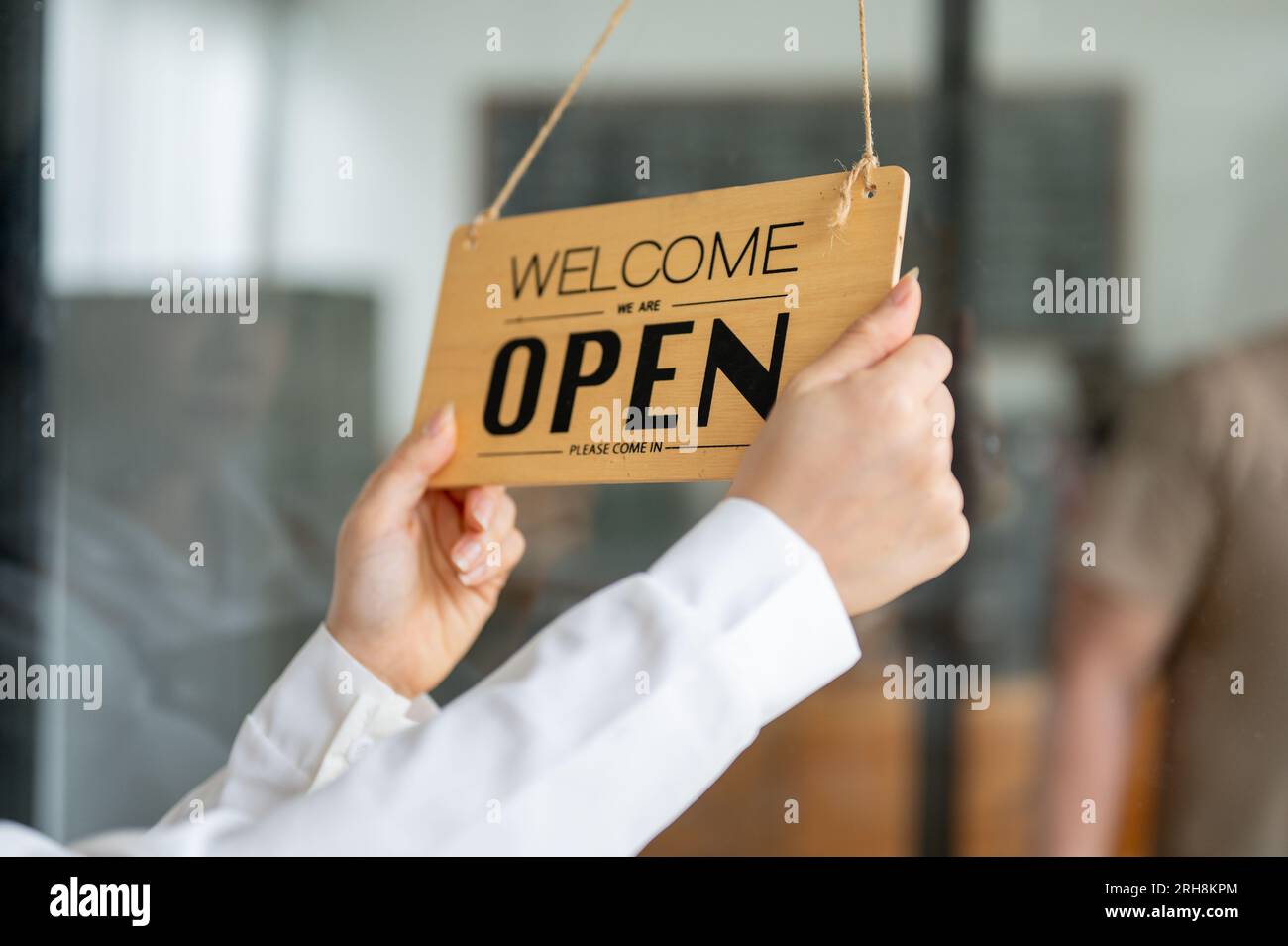 Close-up hand image of a female restaurant staff or waitress is hanging ...