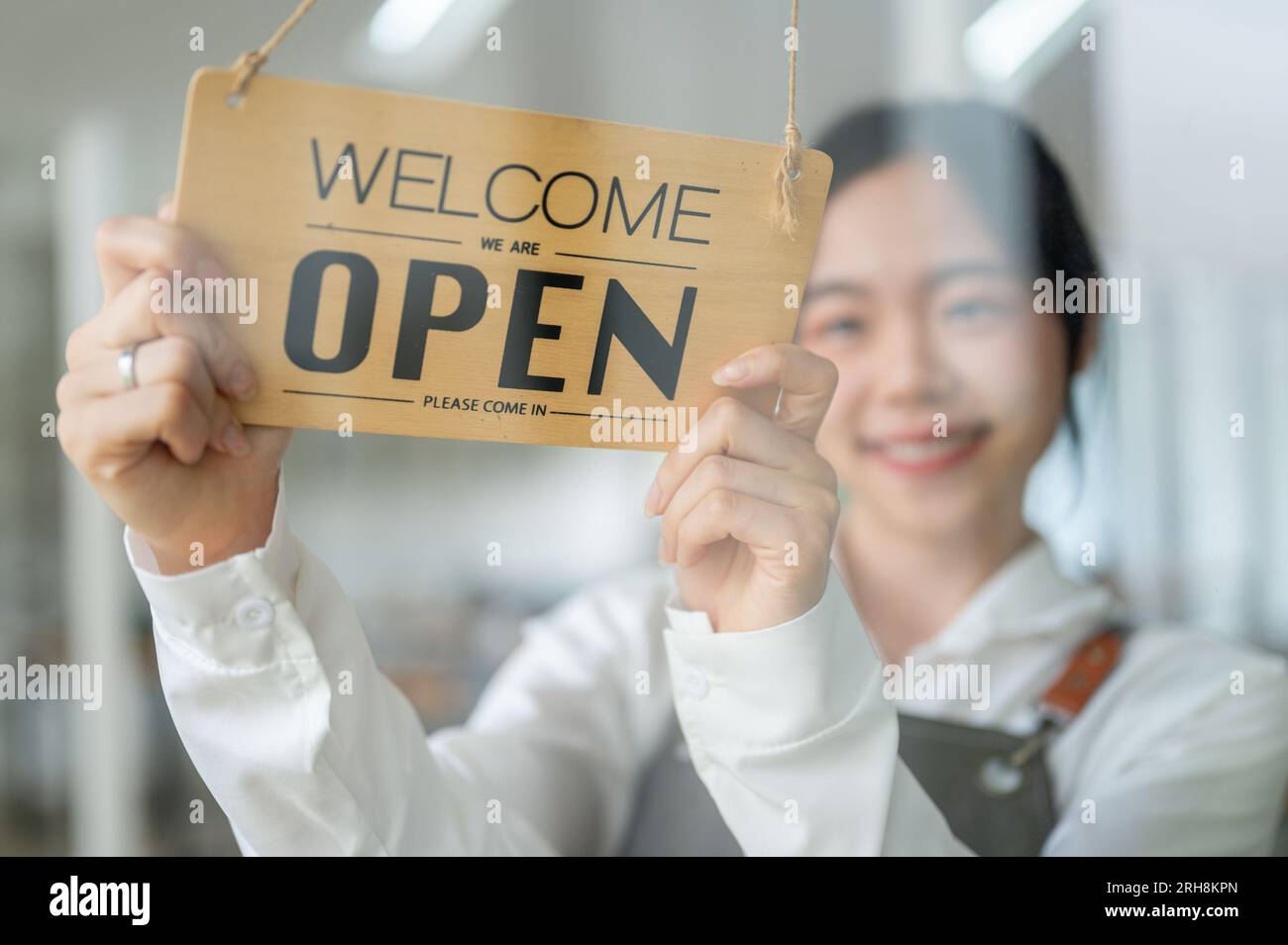 Close-up image of a happy and pretty Asian female restaurant staff or ...