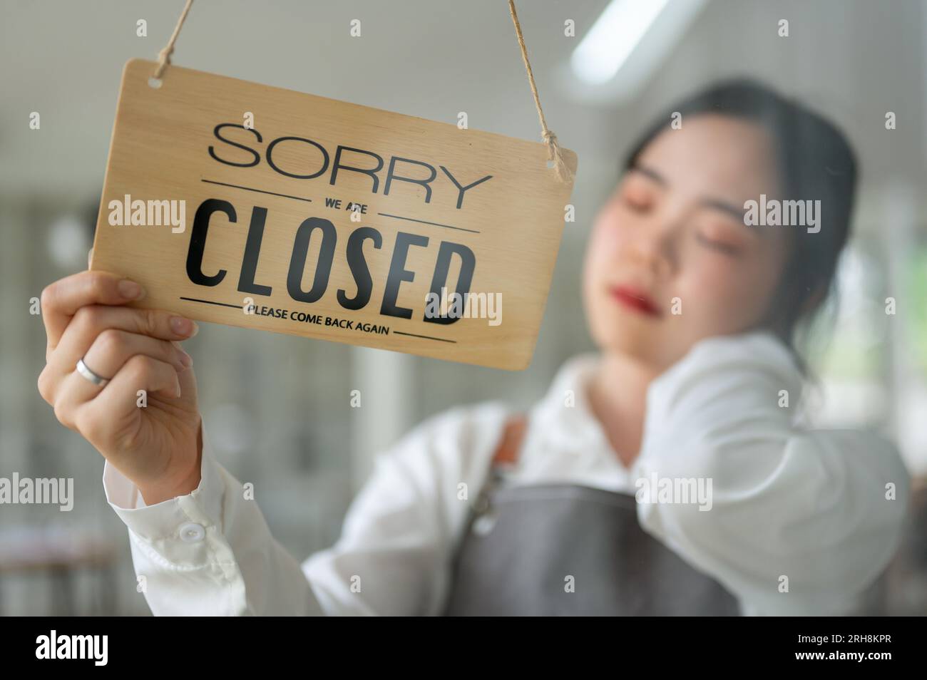 Close-up image of a tired Asian female restaurant staff or waitress is ...