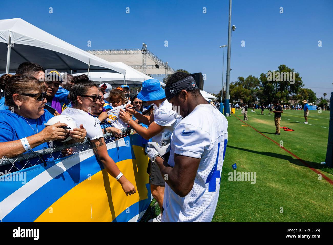 Los Angeles Chargers running back Elijah Dotson (42) give autographs to ...
