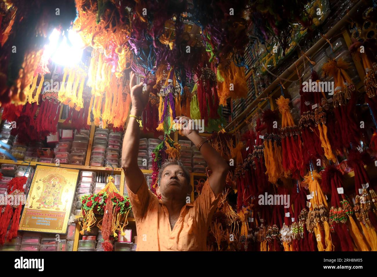 A shop owner arranging "Rakhi", sacred threads for the upcoming "Raksha ...