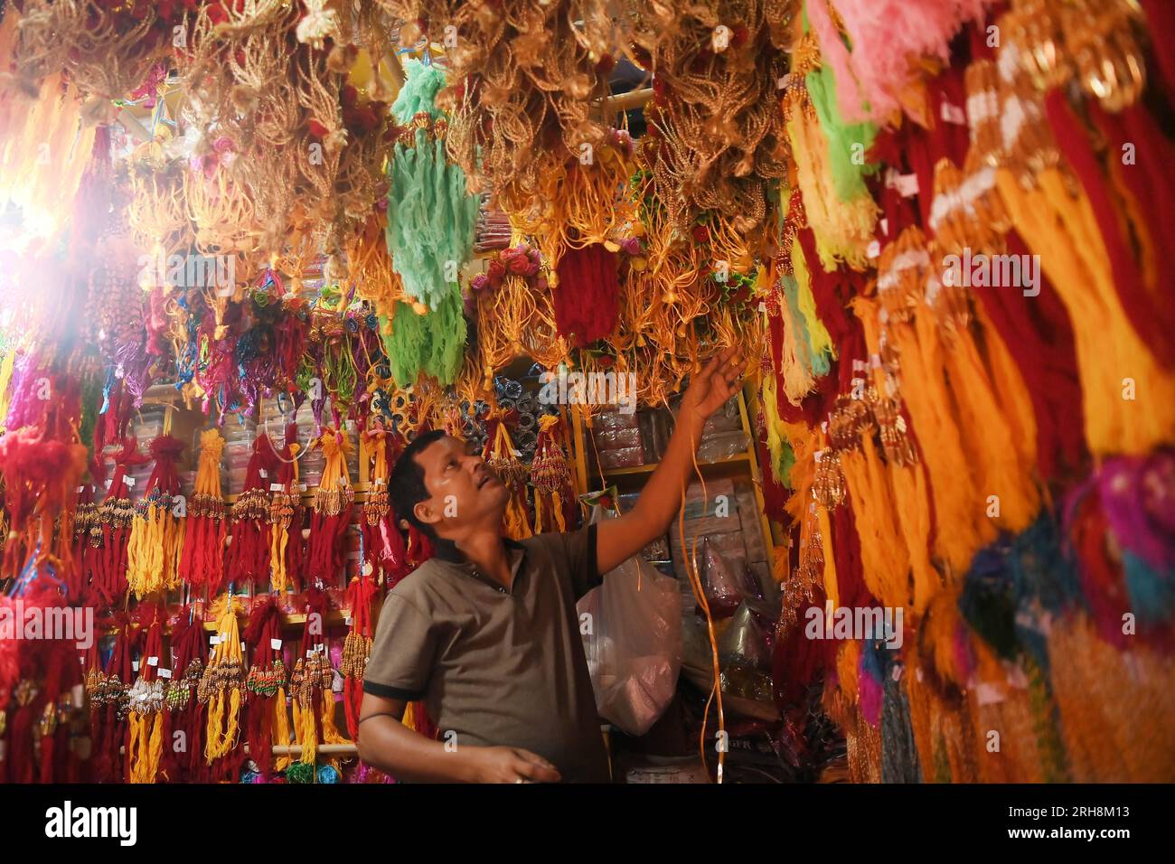 A shop owner arranging "Rakhi", sacred threads for the upcoming "Raksha ...