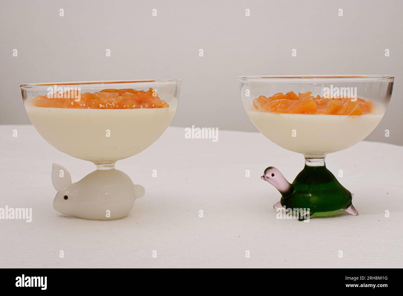 Panna Cotta served with peaches in a bunny and turtle cup Stock Photo ...