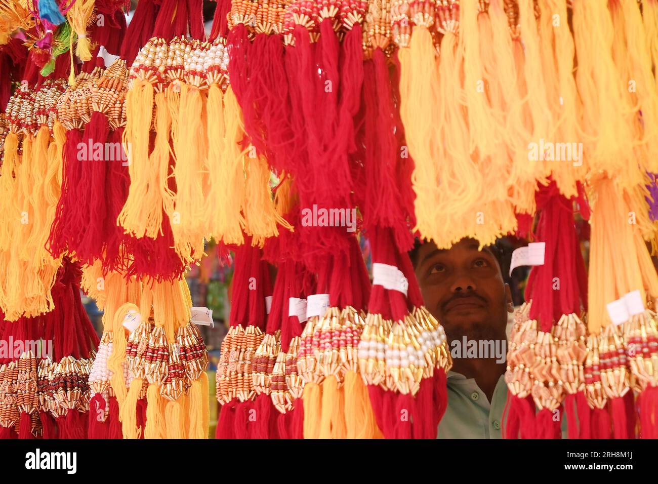 A shop owner arranging "Rakhi", sacred threads for the upcoming "Raksha ...