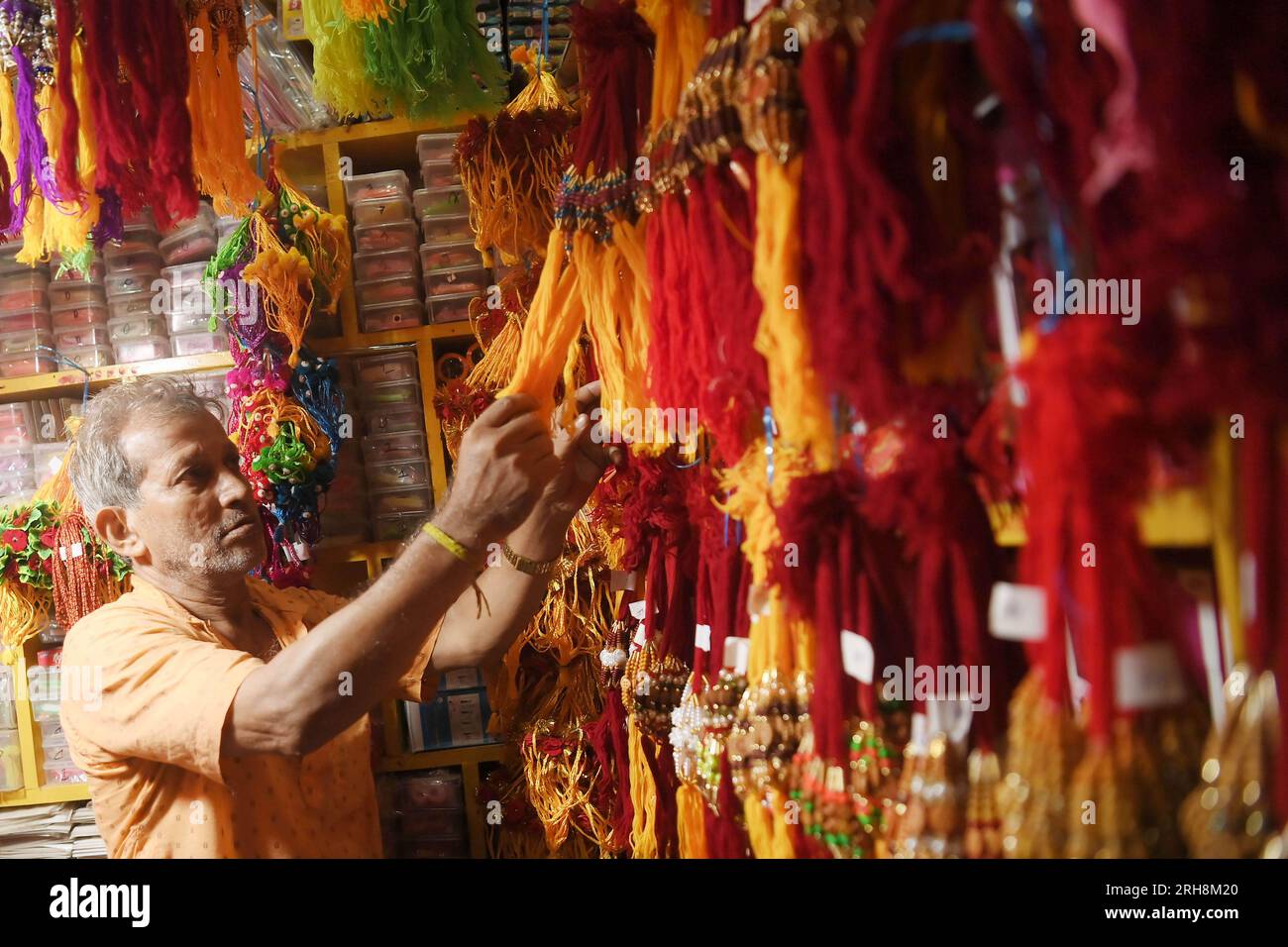 A shop owner arranging "Rakhi", sacred threads for the upcoming "Raksha ...