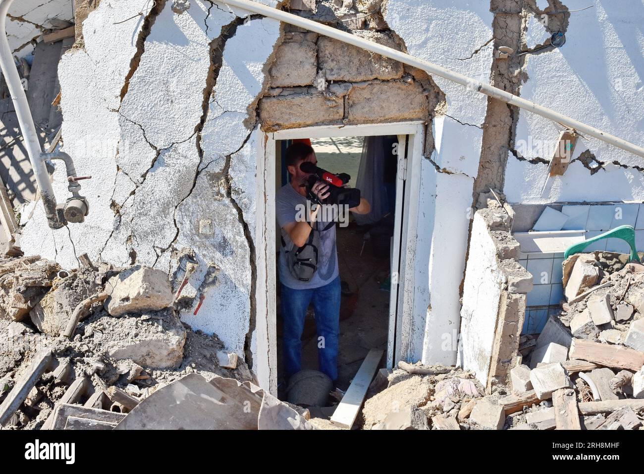 A cameraman of Ukrainian TV channel is seen shooting aftermath video ...