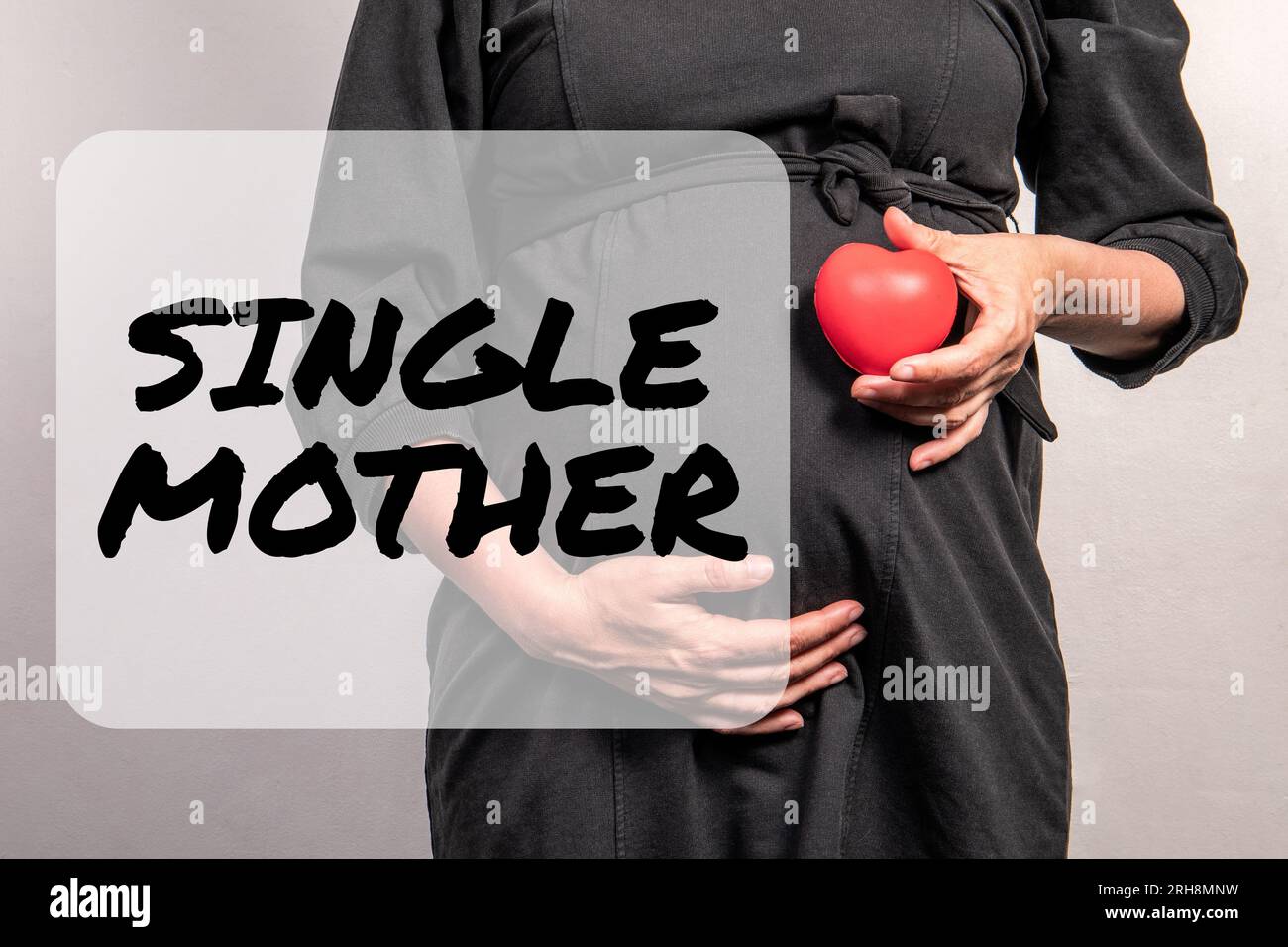 Single Mother. Pregnant woman with a red rubber heart in hand Stock ...