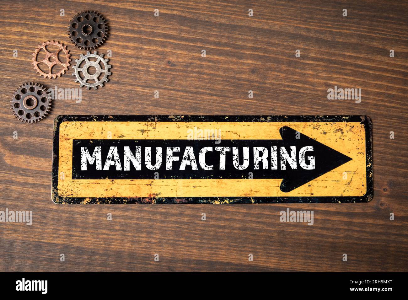 Manufacturing Concept. Direction arrow on wood texture background Stock ...