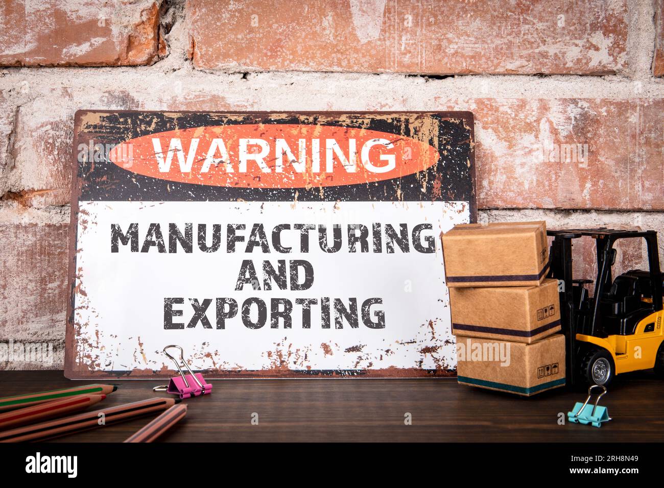 MANUFACTURING AND EXPORTING Concept. Warning sign with text on wooden ...