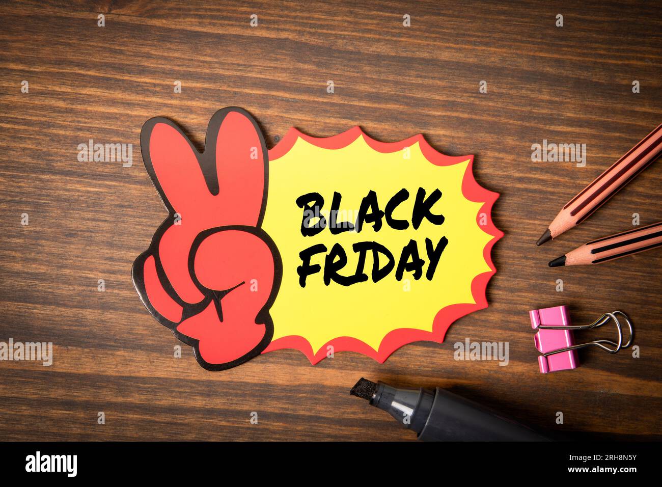 Black Friday. Sticky note with text on a wooden texture background ...