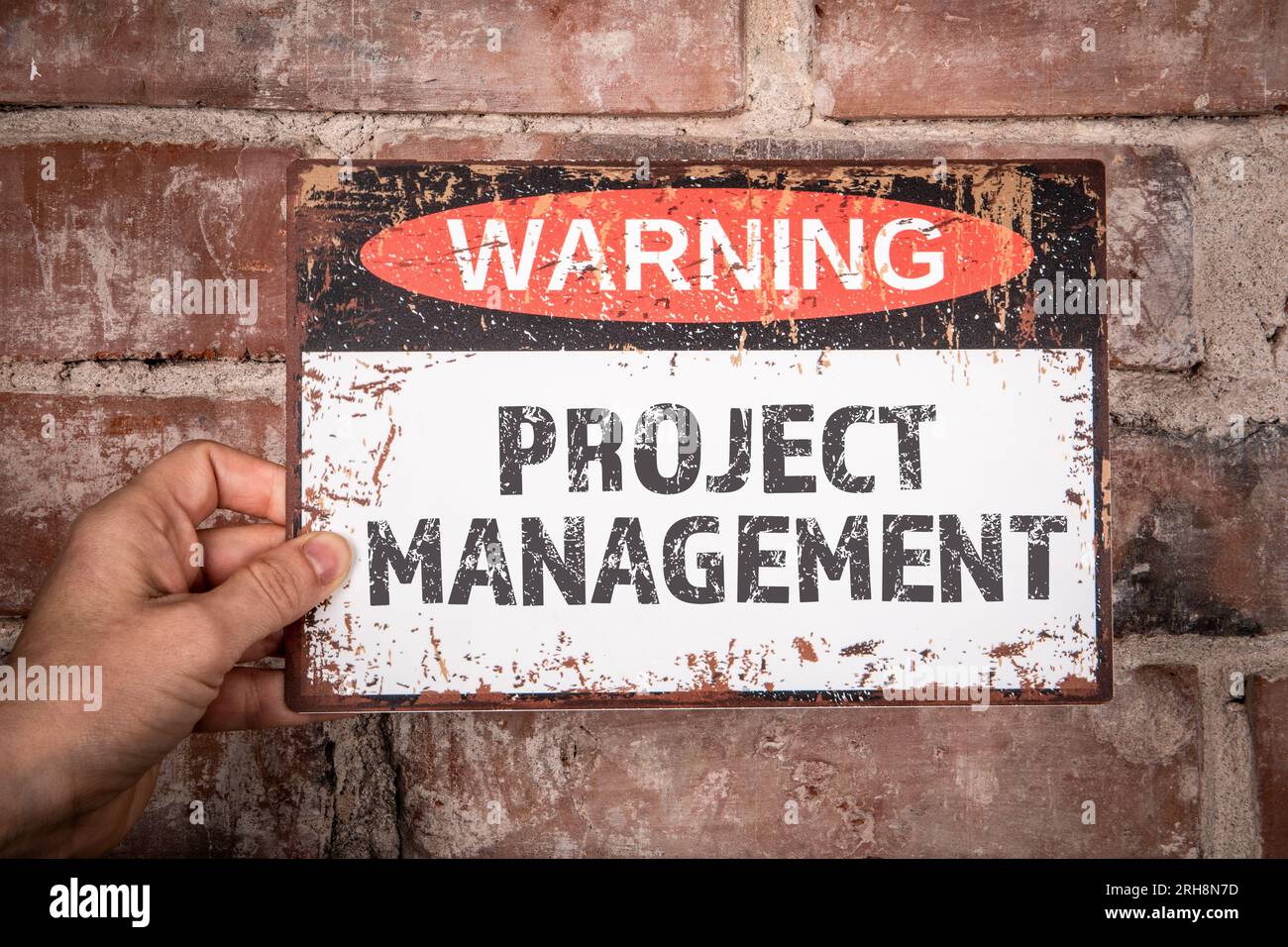 Project Management Concept. Warning sign with text in the hands of a ...
