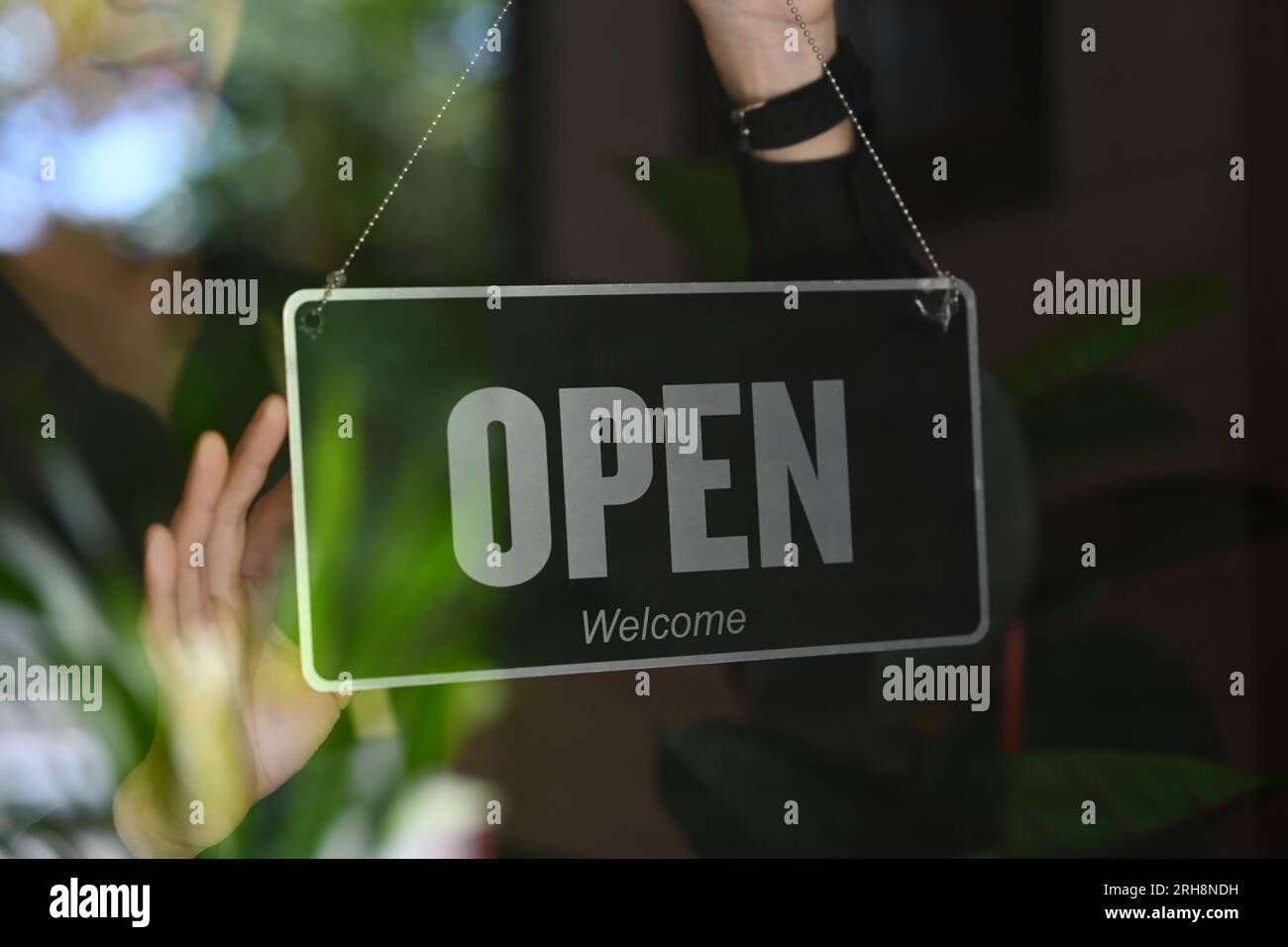 Man coffee shop or restaurant owner turning Open sign on the entrance ...