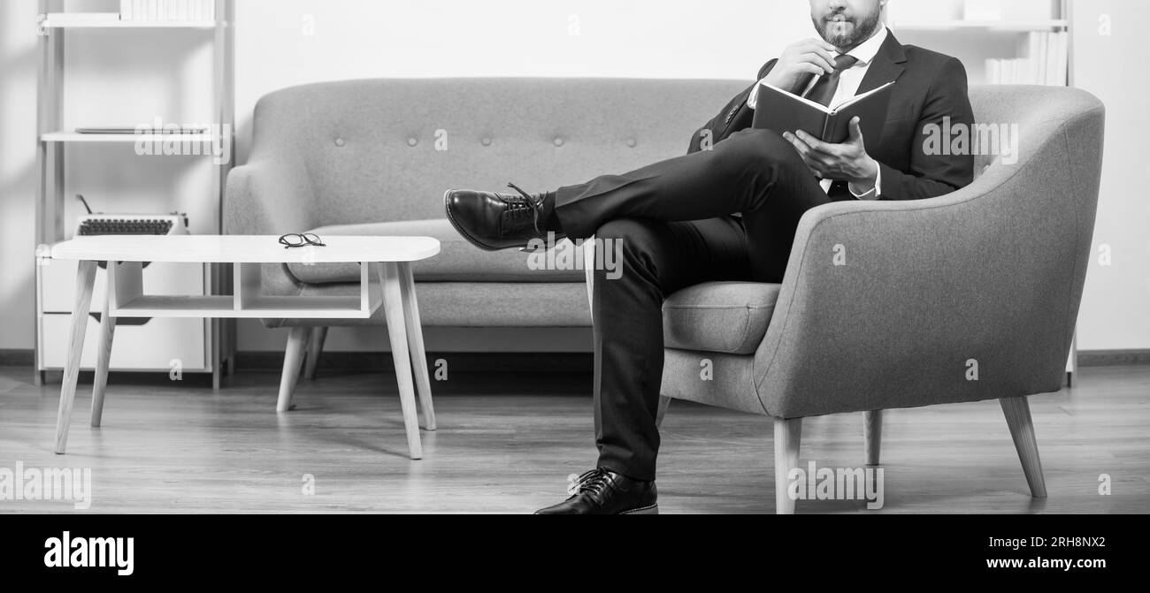 mature businessman smile in suit sit in office reading book Stock Photo ...