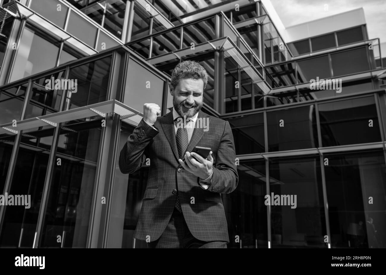 aggressive entrepreneur in businesslike suit hold phone outside the ...
