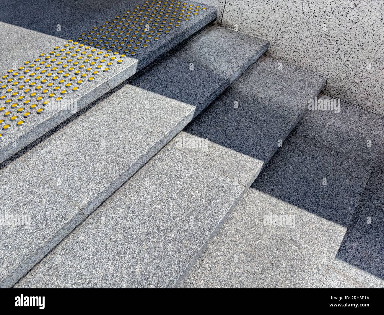 granite staircase with yellow nonskid bumpy markings for visually ...