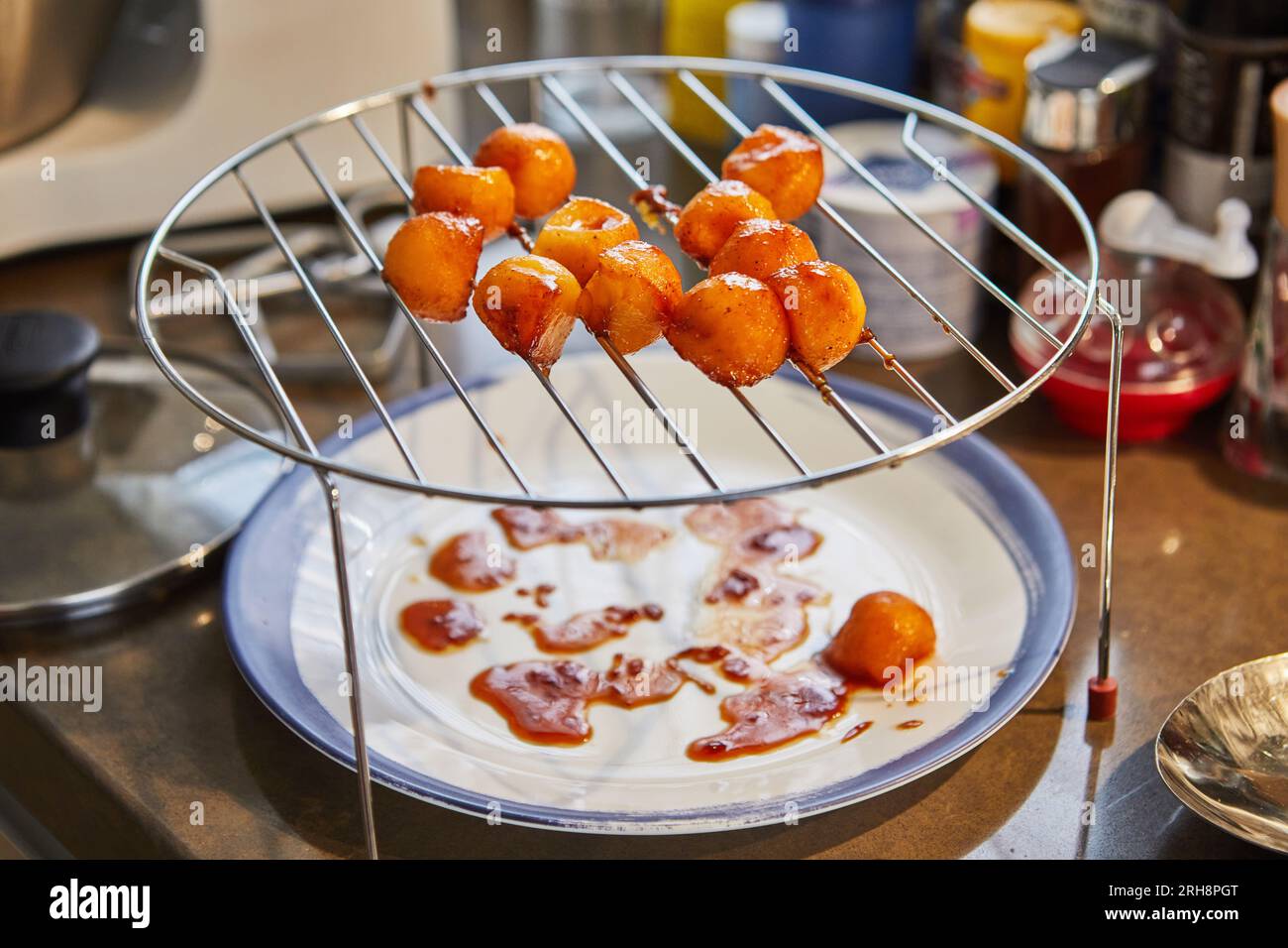Melon balls, cut with a special spoon, fried in caramel Stock Photo - Alamy
