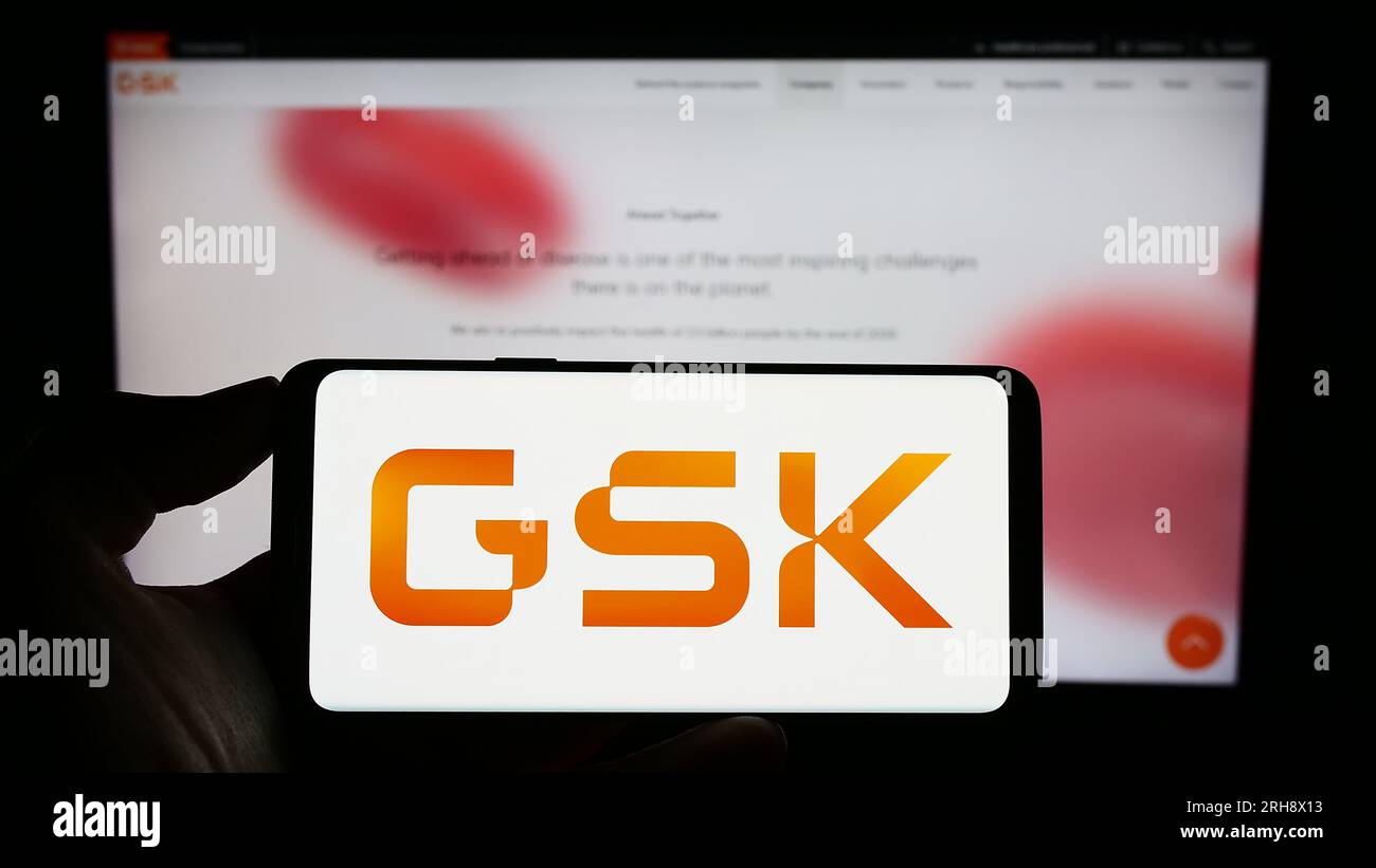 Person holding smartphone with logo of British pharmaceutical company ...