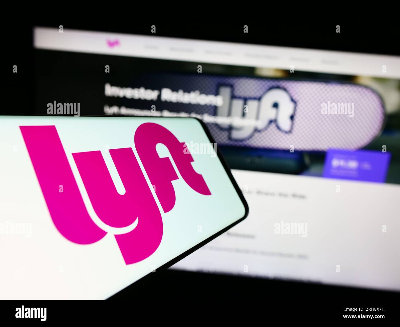 Mobile phone with logo of American mobility company Lyft Inc. on screen ...